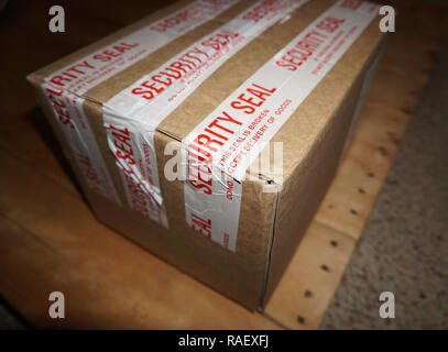shipping box with security seal tape "if this seal is broken, do not ...