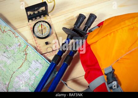 compass, map, trekking poles and backpack on a wooden background Stock ...