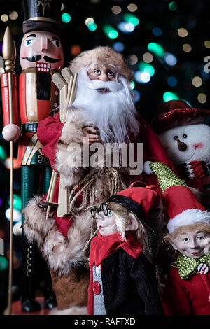Christmas elf dolls in red clothes with candles in festive window ...