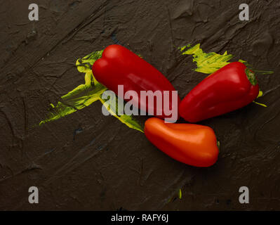 Mini sweet capsicum pepper against dark background with yellow flecks ...