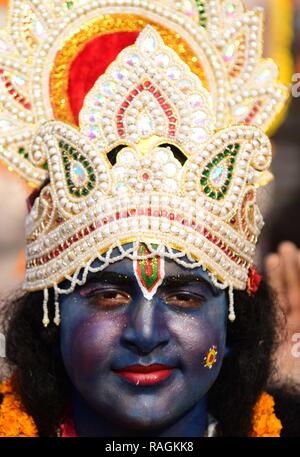 Allahabad, India. 03rd Jan, 2019. A devotee blowing conch shell as ...