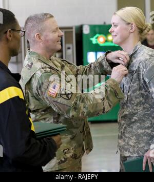 Col. Edwin Larkin, Commandant, Professional Education Center, pins the ...