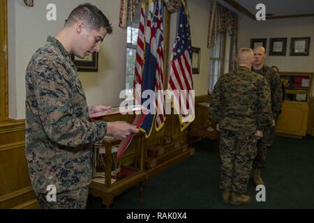 U.S. Marine Corps Devin Capece, commanding generals’ aide, reads a ...