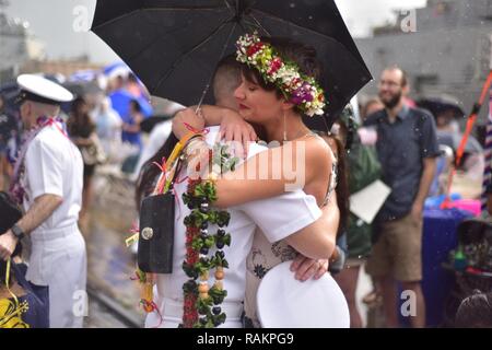 Julie Yaste embraces her husband, Lieutenant Commander Cameron Yaste ...