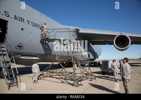 Maintainers from 349th Aircraft Maintenance Squadron place covers over ...