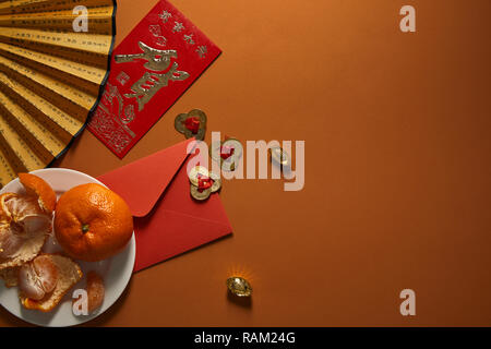 Mandarins and Chinese symbols on red background, closeup Stock Photo ...