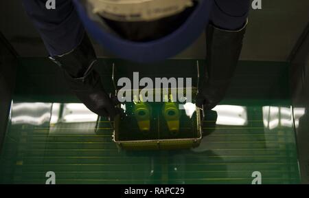Fluorescent dye penetrant test on a metallic component, viewed under ...