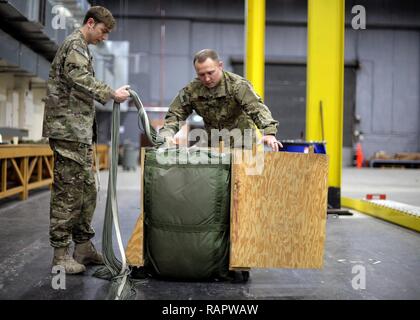 A U.S. Army parachute rigger (left) assigned to the 173rd Airborne ...