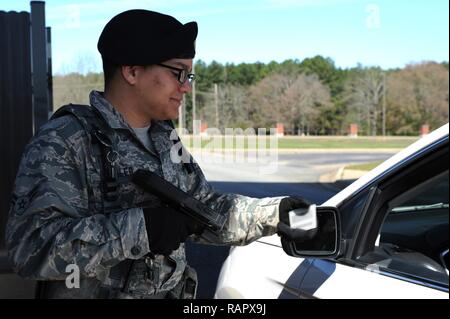 A US Army Soldier uses a biometric camera to store data for a worker on ...