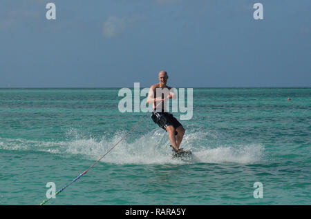 Guy wakeboarding in Aruba off of Palm Beach Stock Photo - Alamy
