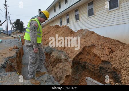 Chief Warrant Officer 2 Bobby Bowlin examines the progress on the sewer ...