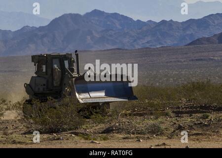 A dozer drives across a forward arming and refueling point during ...