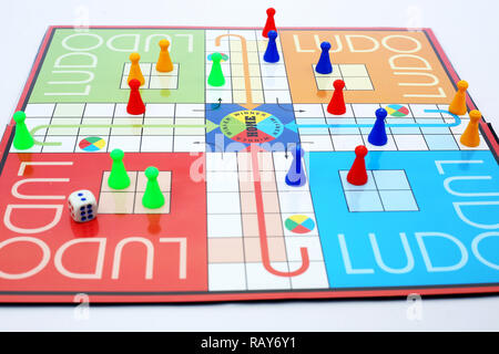Different colors ludo tokens on the ludo game Stock Photo - Alamy