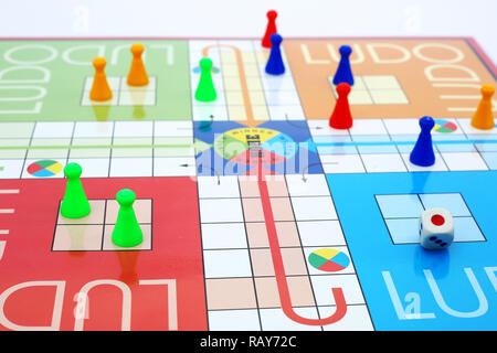 Different colors ludo tokens on the ludo game Stock Photo - Alamy