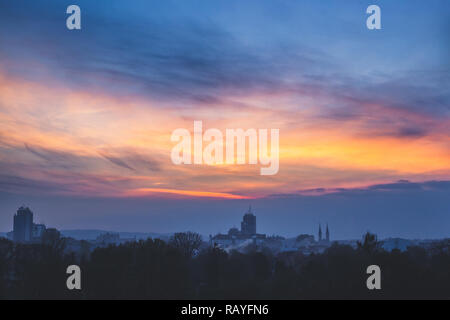 Dim winter twilight. Clouds at sunset over dark industrial town Stock ...
