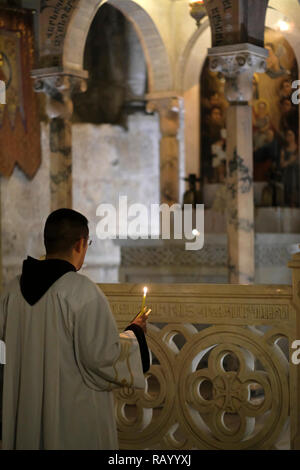 A Franciscan friar praying in Chapel of Mary Magdaleneinside inside the ...