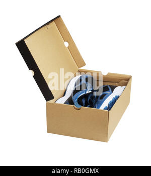 Cardboard box with running shoes on green background Stock Photo - Alamy