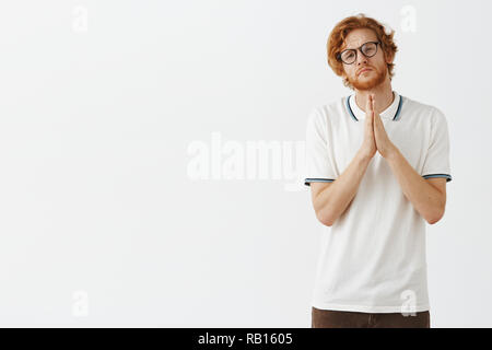 Sad and gloomy redhead male student pouting, frowning and looking ...