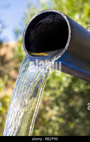 Water falling out of drain pipe Stock Photo - Alamy
