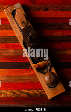 Wooden hand plane. Closeup of woodworker's hands shaving with a plane ...
