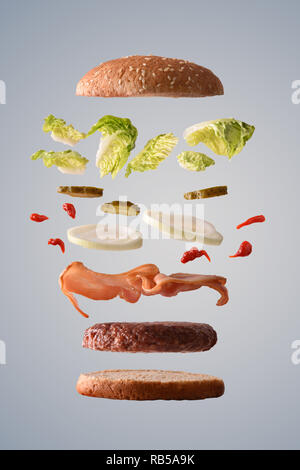 Exploded conceptual view of hamburger isolated on white Stock Photo - Alamy