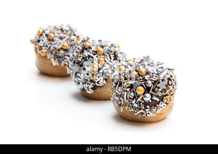 Homemade profiteroles covered with coloured sugar sparkles isolated on ...