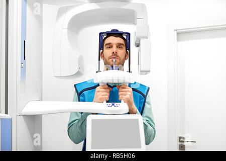 CT scanning. Male patient having his head scanned in a CT (computed ...