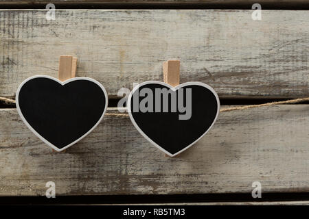 Heart shape decorations hanging on thread Stock Photo - Alamy