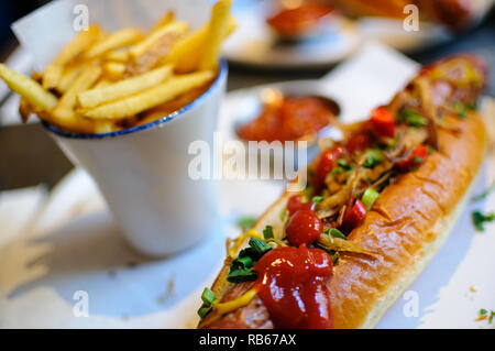 British Hot Dog with onions mustard half eaten Stock Photo - Alamy
