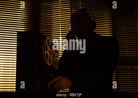FBI agent eavesdropping on a directional microphone Stock Photo - Alamy