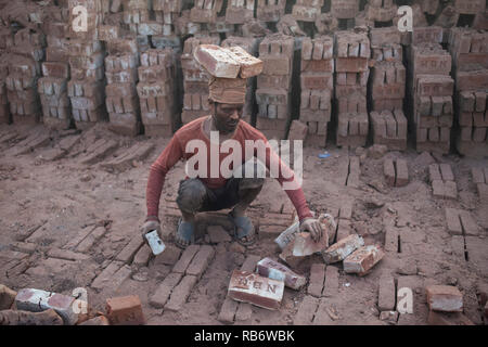 Picking up bricks at a brick making factory in Bangladesh Stock Photo ...