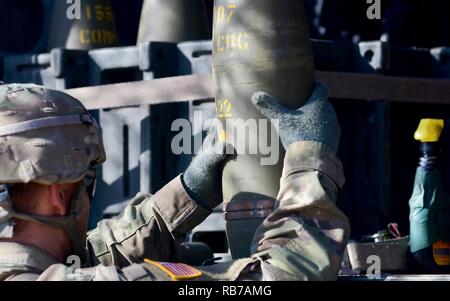 U.S. Army paratroopers prepare 155mm rounds for firing with M777A2 ...