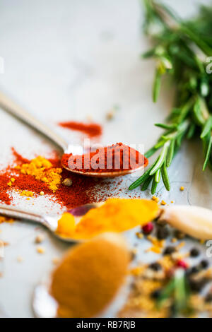 Various colorful condiments on spoons Stock Photo - Alamy