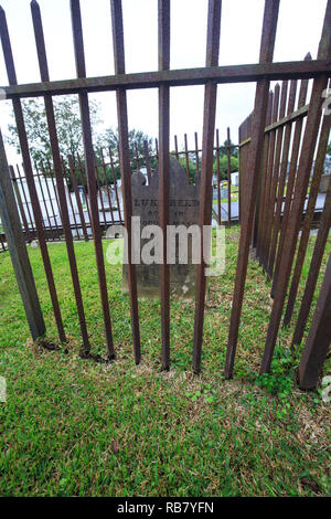 Wrought-iron fence surrounding a grave plot in a cemetery in ...