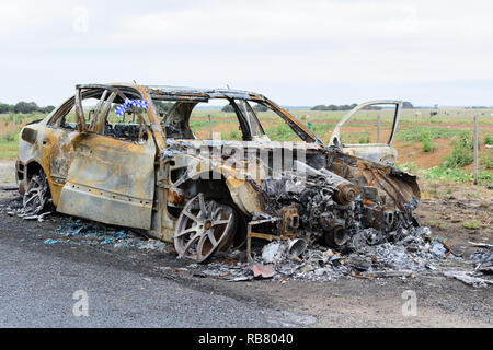 A Holden Commodore torched after a joyride Stock Photo - Alamy
