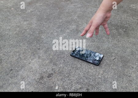 Smartphone fall out of hand and fall to the cement floor and the touch ...