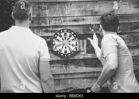 Man throwing a dart at the dart game. Canadian National Exhibition ...