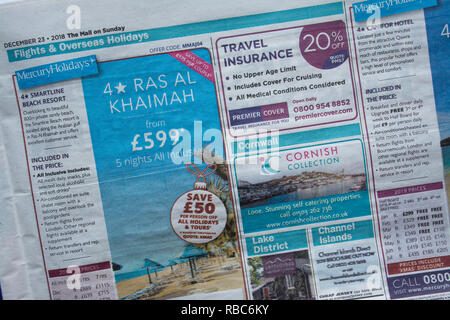 Travel section page in newspaper The Sun UK Stock Photo - Alamy
