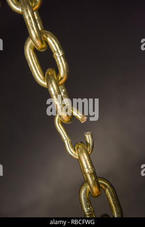 Weakest link in a strong steel rusty roller chain is broken snapped ...