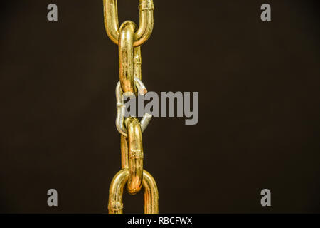 Weakest link in a strong steel rusty roller chain is broken snapped ...