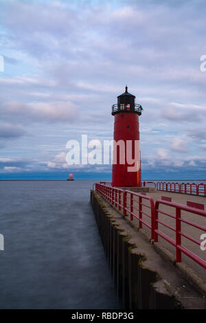 The "Milwaukee Pier Head Lighthouse" as the sun sets and the rain ...
