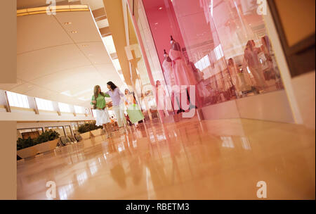 Female Friends Walking Through Mall With Shopping Bags Stock Photo - Alamy