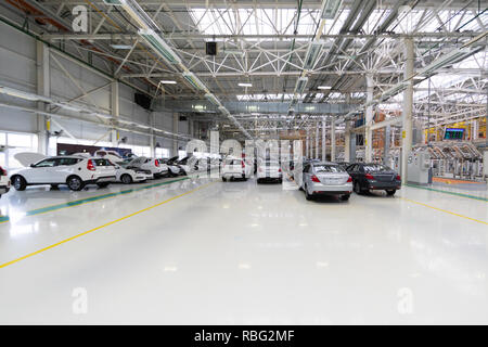 Brand new auto body shop for luxury cars with two cars parked inside ...