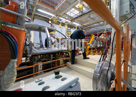 Workers assemble a vehicle body. process of welding cars. Modern ...
