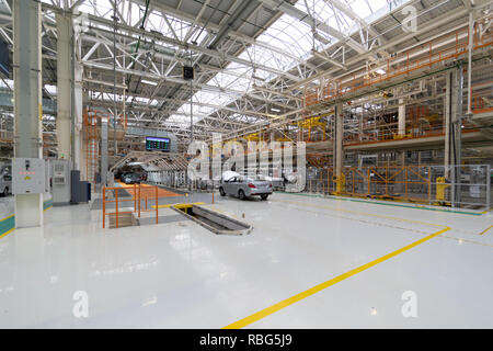 Brand new auto body shop for luxury cars with two cars parked inside ...