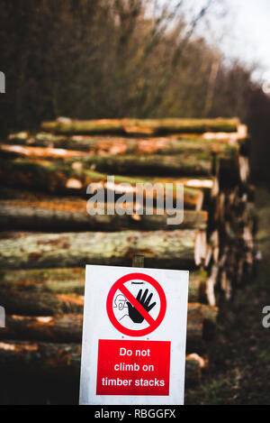 Warning / Danger Sign. Fresh cut and stacked logs / timber. Natural ...