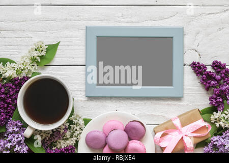 Vintage mock up frame with lilac flowers, pink notebook and pen. Copy ...