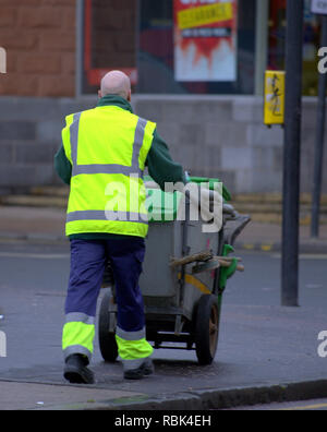 dustman street sweeper crossing road pushing dust cart with brushes ...