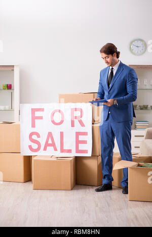 Young handsome realtor selling flat Stock Photo - Alamy