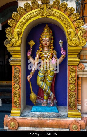This sculpture of the Hindu god Vishnu, holding lotus flowers, is part ...